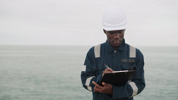 Black Seaman Taking Notes Near Sea, Stock Footage | VideoHive