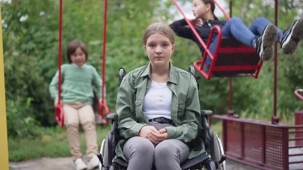 Medium Shot Sad Paraplegic Girl in Wheelchair Looking at Camera Sighing ...