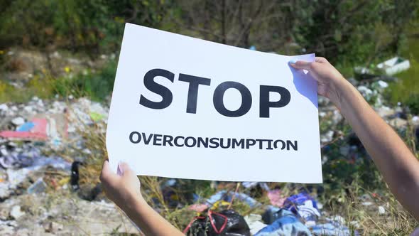 Stop Overconsumption Phrase on Cardboard in Hands Against Landfill ...