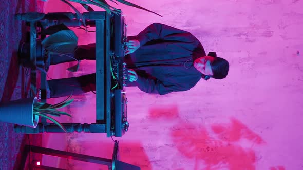Modern DJ of Asian Appearance Performs a Music Track in Neon Lighting ...