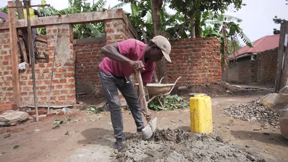 Constructing a traditional house in Africa. African worker Man making ...