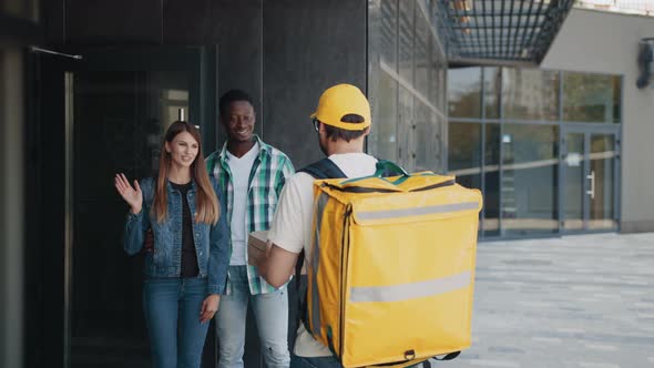 The Courier Brings Pizza to Customers and is Happy to Fulfill Orders ...