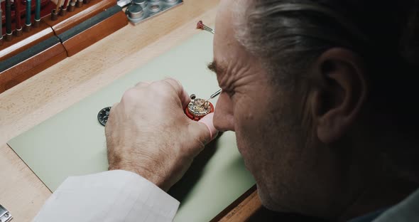 Man Inspecting And Repairing Wrist Watch - close up, Stock Footage