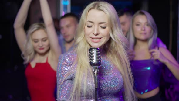 Gorgeous Blond Female Singer Performing on Stage in Night Club Lights ...
