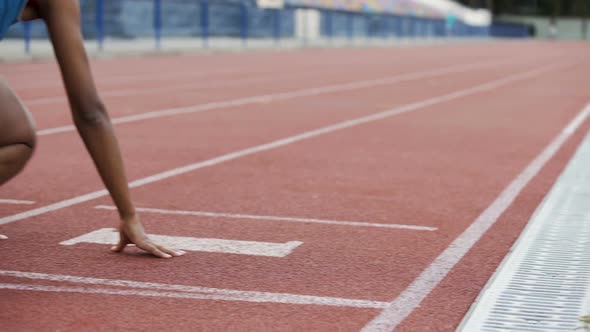 Multiracial girls getting to crouch start, running after command, way ...