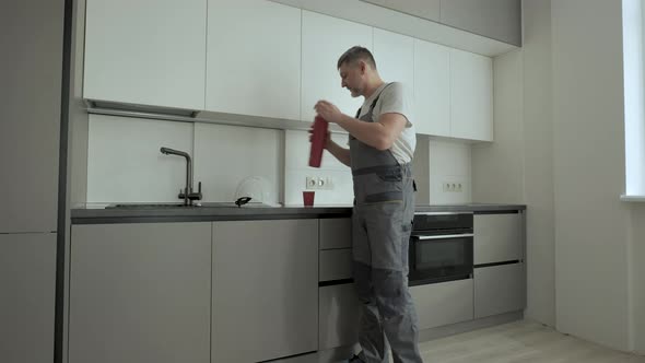 The Worker Rests and Drinks Tea in the New Kitchen, Stock Footage ...