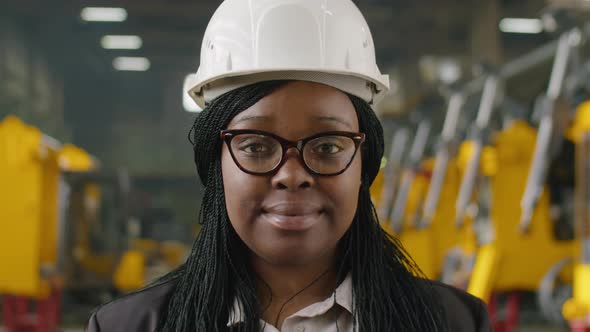 Portrait of African American Female Engineer at Heavy Equipment Factory ...