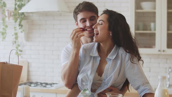 Portrait of Young Married Couple Flirting at Home Kitchen in Slow ...