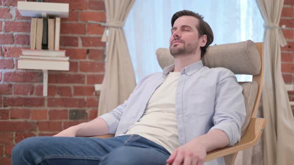 Young Man Taking Nap While Sitting on Sofa, Stock Footage | VideoHive