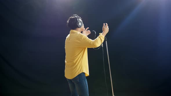 Young Boy With Headphone Rapping Into A Condenser Microphone On The ...