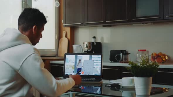 Back View of African Man Watching Online Video Conference on Computer ...