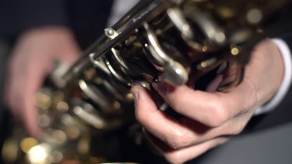 Saxophonist plays with fingers on the saxophone valves close-up., Stock ...