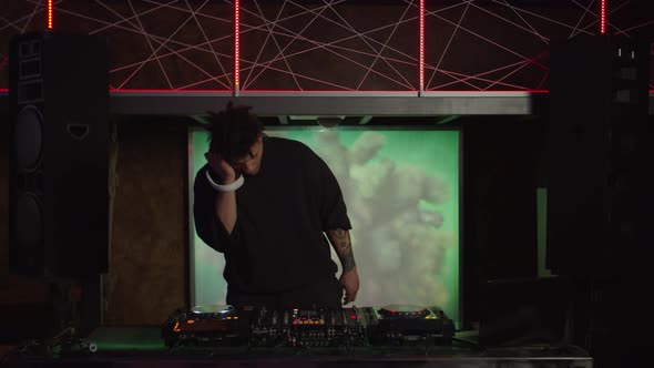 African American DJ Playing Live Set and Mixing Music on Turntable ...