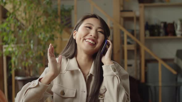A Beautiful Woman is Smiling While Talking on the Phone, Stock Footage