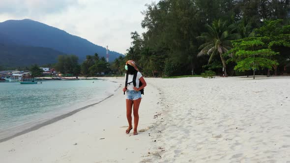 Women tanning on idyllic tourist beach vacation by transparent water ...