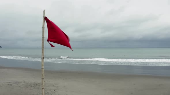 Circling around a red flag on the beach alongside a lifeguard post ...