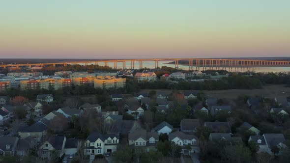 Aerial view of neighborhood surrounding Wando River Bridge at sunset ...