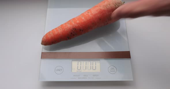 Weighing Carrot on a Kitchen Scale, Stock Footage | VideoHive