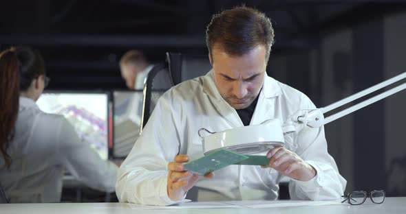 Male Engineer Using Magnifying Glass To Check Details, Stock Footage