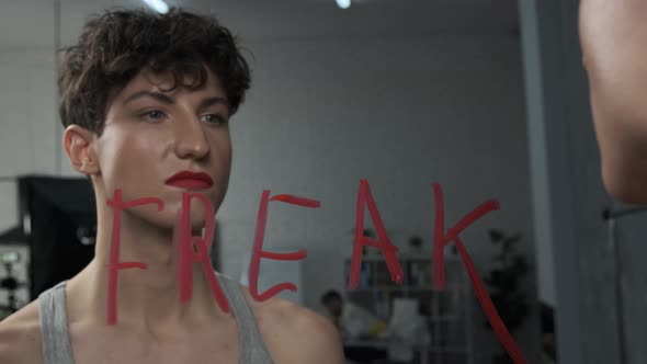 Angry Trans Man Stares at the Word FREAK on the Mirror, Stock Footage