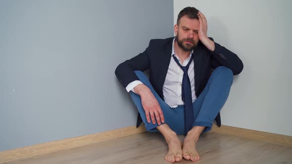 Upset Bearded Man in Untidy Formal Clothes Is Sitting in an Empty ...