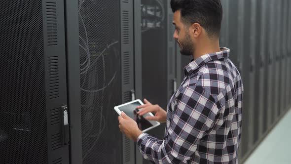 Male informatic engineer working inside server room database, Stock Footage