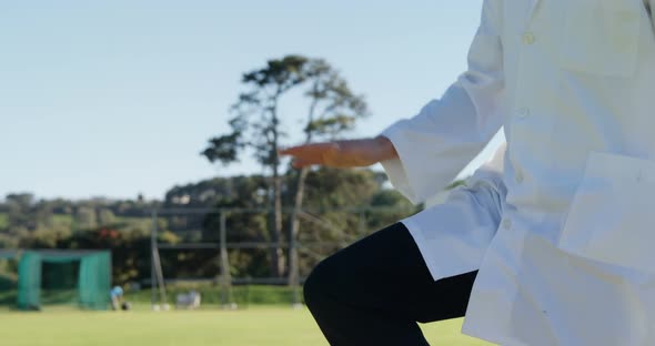 Cricket umpire signaling a leg bye during match, Stock Footage | VideoHive