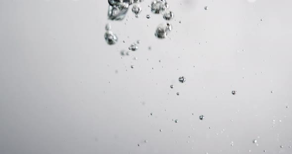 Bubbles Rising In Water As Liquid Is Poured Into It, Stock Footage