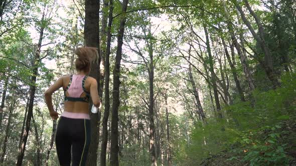 Tracking Camera of Girl Running in the Forest, Jumping Off Tree Trunks ...