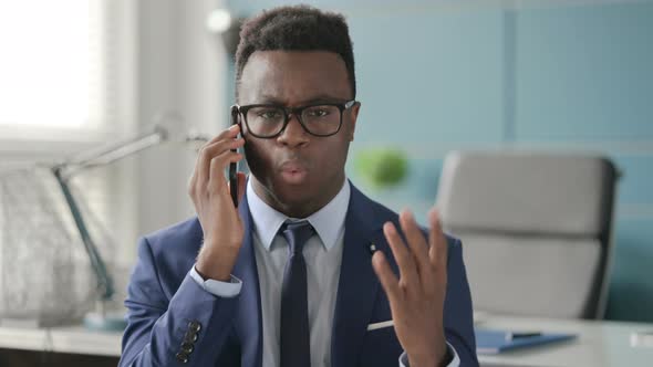 Portrait of African Man Talking Angrily on Smartphone, Stock Footage