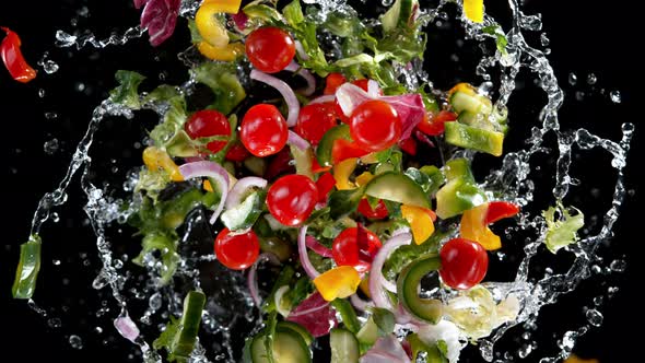 Super Slow Motion Shot of Rotating Exploded Salad and Splashing Water ...
