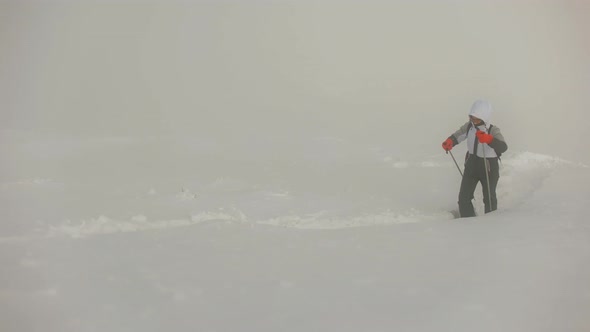 A Young Woman is Walking Through Deep Snow, Stock Footage | VideoHive