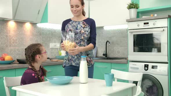 Mom Cooking Breakfast for Daughter, Stock Footage | VideoHive