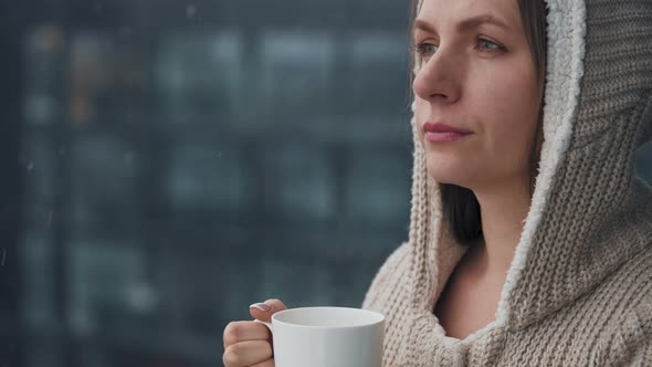 Woman Stays on Balcony During Snowfall with Cup of Hot Coffee or Tea ...