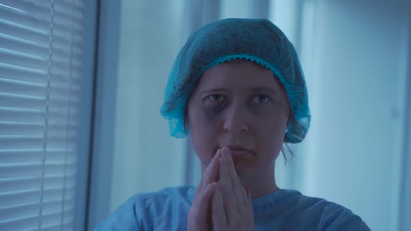 Stressed Woman with Facial Injuries Crying and Praying in Hospital ...