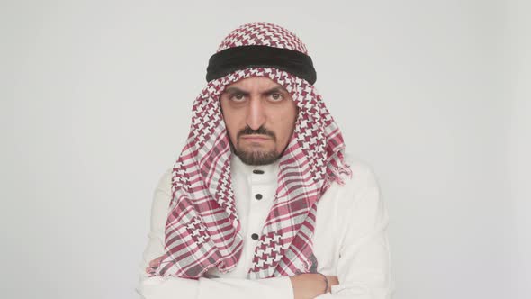 An Evil Sheik in a White Kandura and Gutra Shakes His Head. A Man of ...