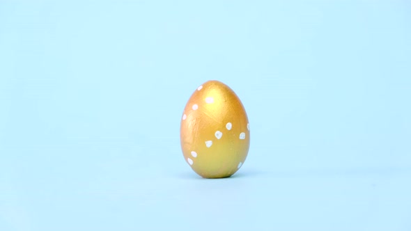 Easter Eggs are Rolling Knocking Each Other on Blue Table, Stock Footage