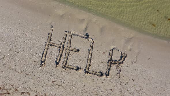 HELP written in the sand gets larger., Stock Footage | VideoHive