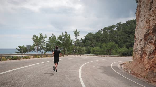 Male runner running fast on mountain road, Stock Footage | VideoHive