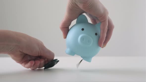 Hands Shaking Coins Out of Piggy Bank, Stock Footage | VideoHive