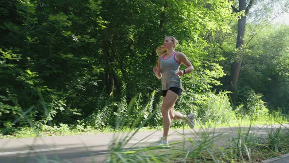 Young Woman Jogging Outside in Summer, Stock Footage | VideoHive