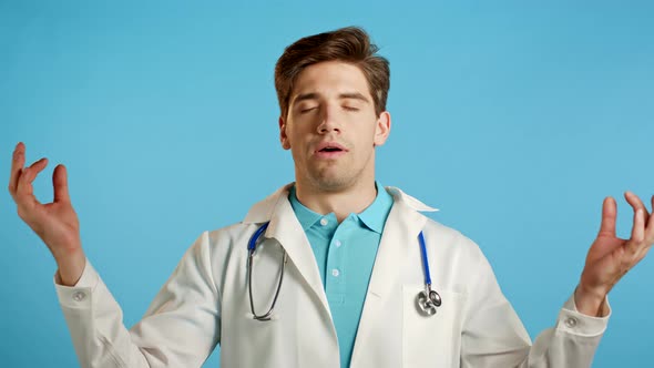 Calm Doctor in White Medical Coat Relaxing, Meditating. Man Calms Down ...