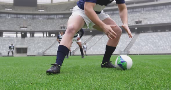 Male player passing rugby ball in the ground at stadium, Stock Footage