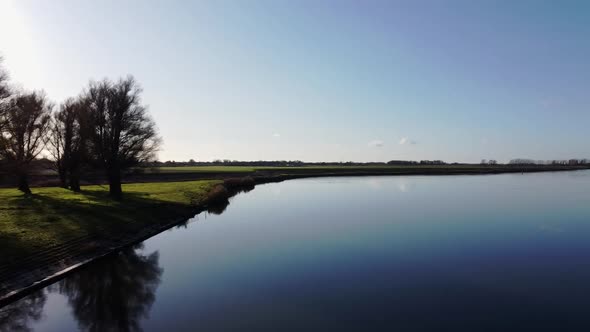 Backlight drone footage of the tidal river Het Spui in Holland with ...
