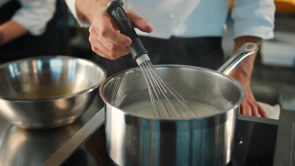 Close-up: stirring milk in a bowl on the stove, Stock Footage | VideoHive