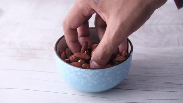 Close Up of Hand Picking Almond From a Bowl , Stock Footage | VideoHive