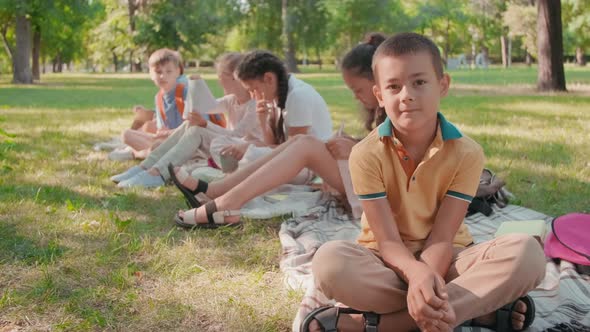 Cute Schoolboy Posing for Camera during Outdoor Lesson, Stock Footage