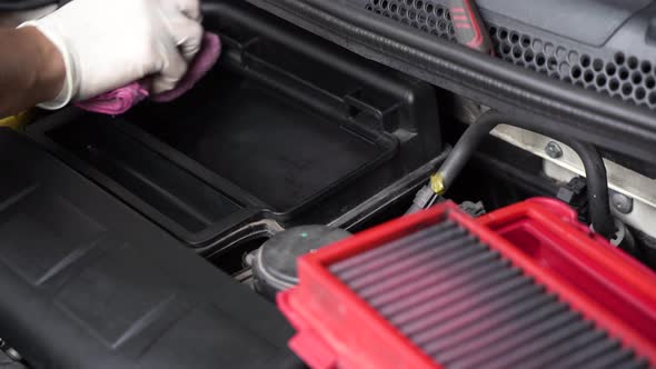 An auto mechanic is cleaning the engine compartment. car service. close ...