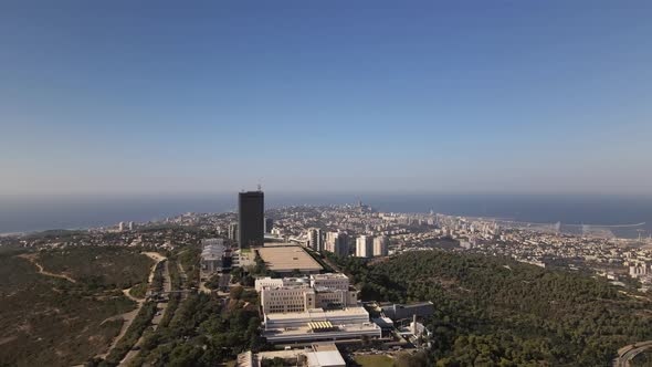 Tranquil skyline of Haifa city with a tall building on a hill and a ...