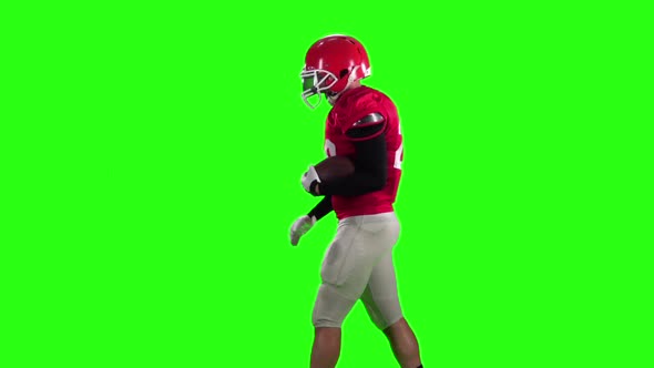 Football Player in a Red Helmet Comes with a Ball. Slow Motion, Green ...